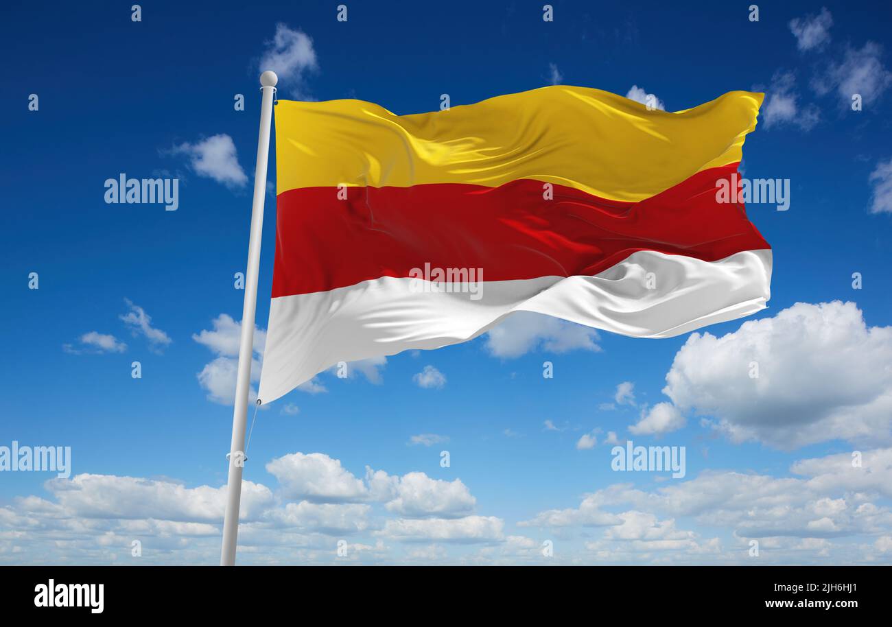 official flag of Carinthia Austria at cloudy sky background on sunset ...