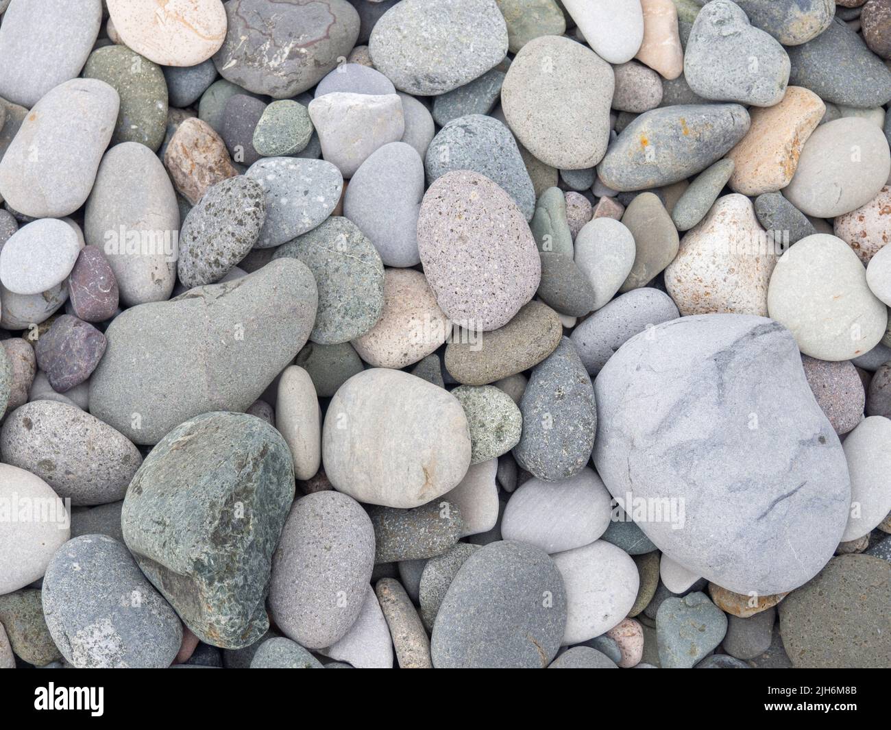 Big stones on the beach. Background from stones. Boulders on the ...