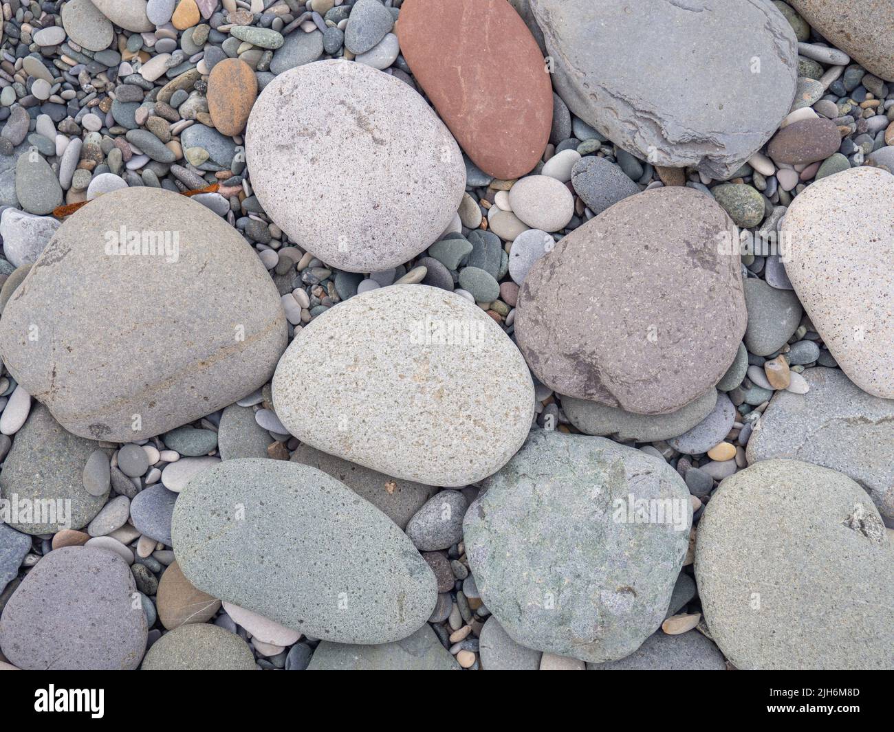 Big stones on the beach. Background from stones. Boulders on the ...