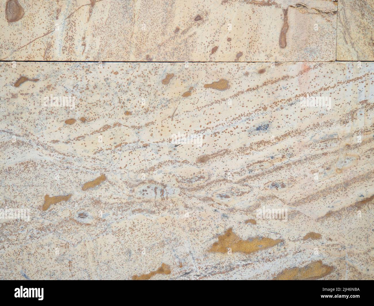 Yellow-brown material. Church cladding. Background from stone tiles. Interesting texture. Temple ...