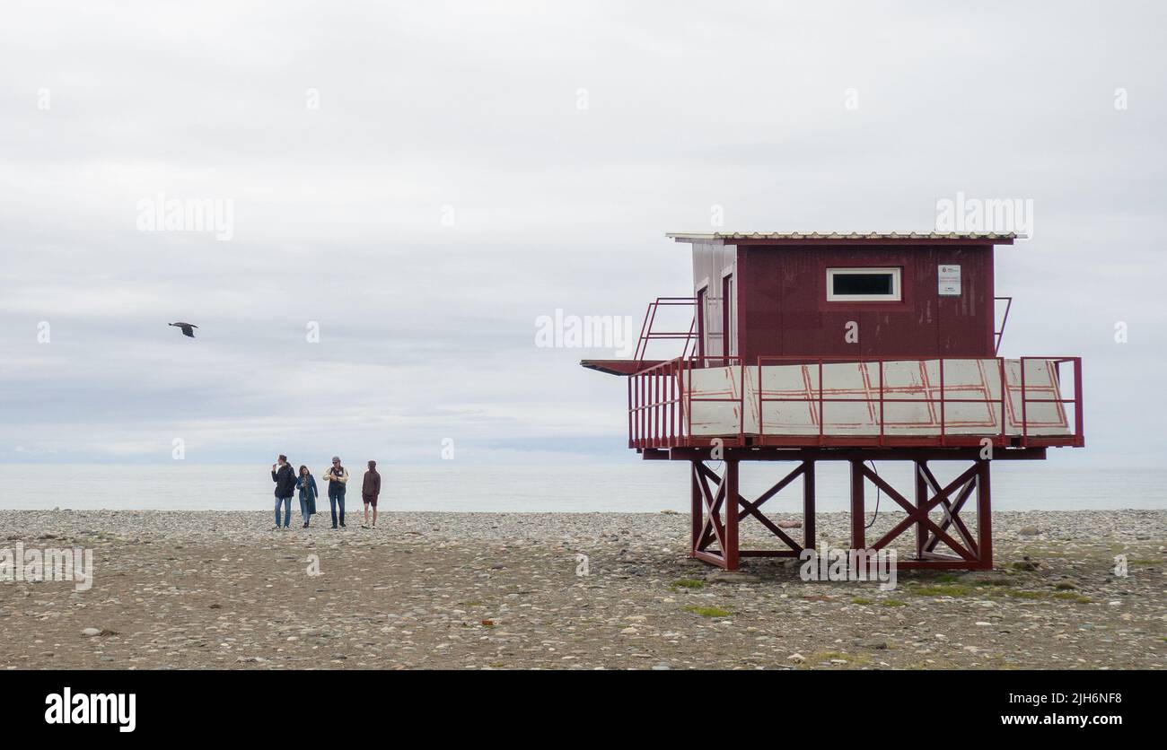 Lifeguard booth on the beach. The beach is out of season. People on the ...