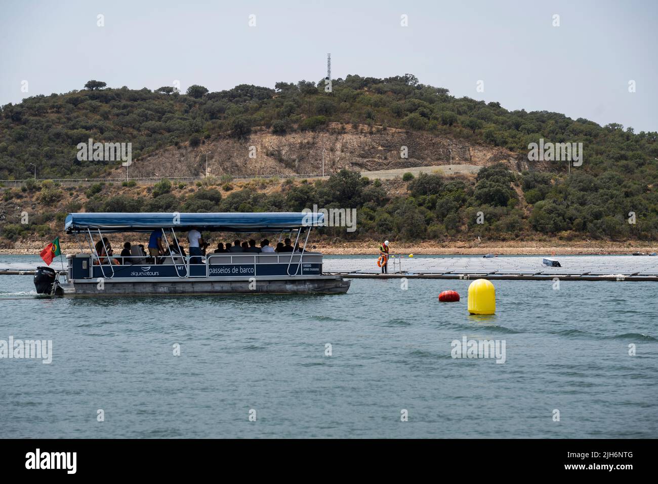 A boat with guests is seen close to the floating solar power plant in ...