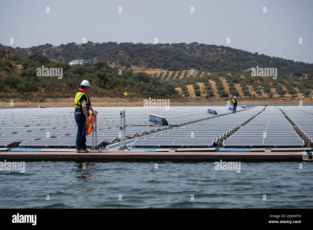 Staff members seen at the floating solar power plant in Alqueva ...