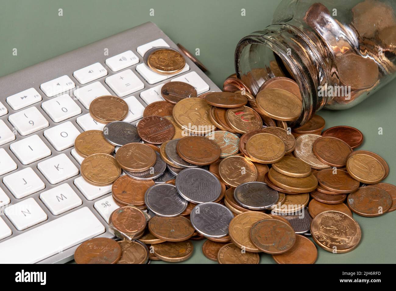 counting coins to spend on internet purchases Stock Photo - Alamy