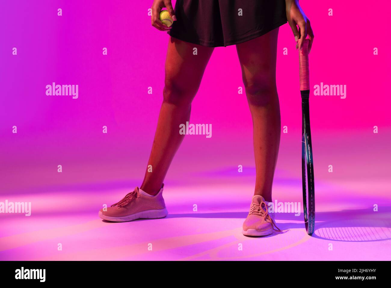 Image of low section of african american female tennis player in violet ...