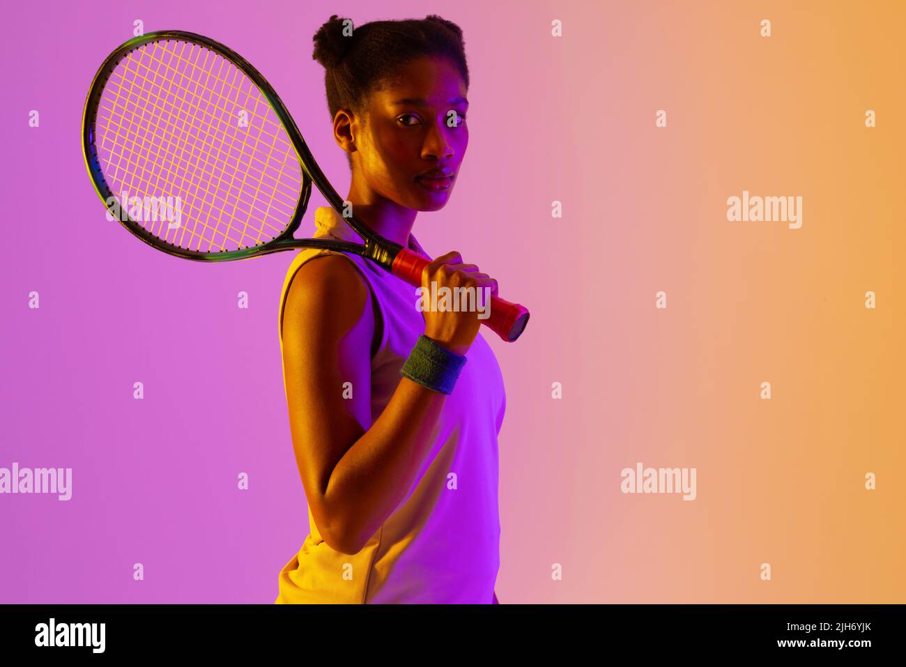 Image of african american female tennis player in neon violet and ...
