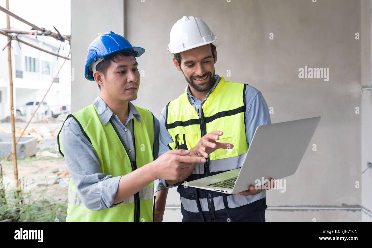 Young engineer with laptop computer explain to foreman about a floor ...
