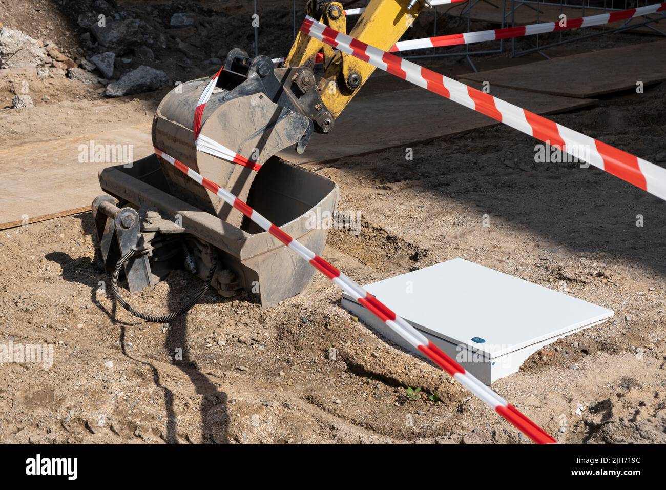 Backhoe loader of excavator wrapped with red striped tape. the concept ...