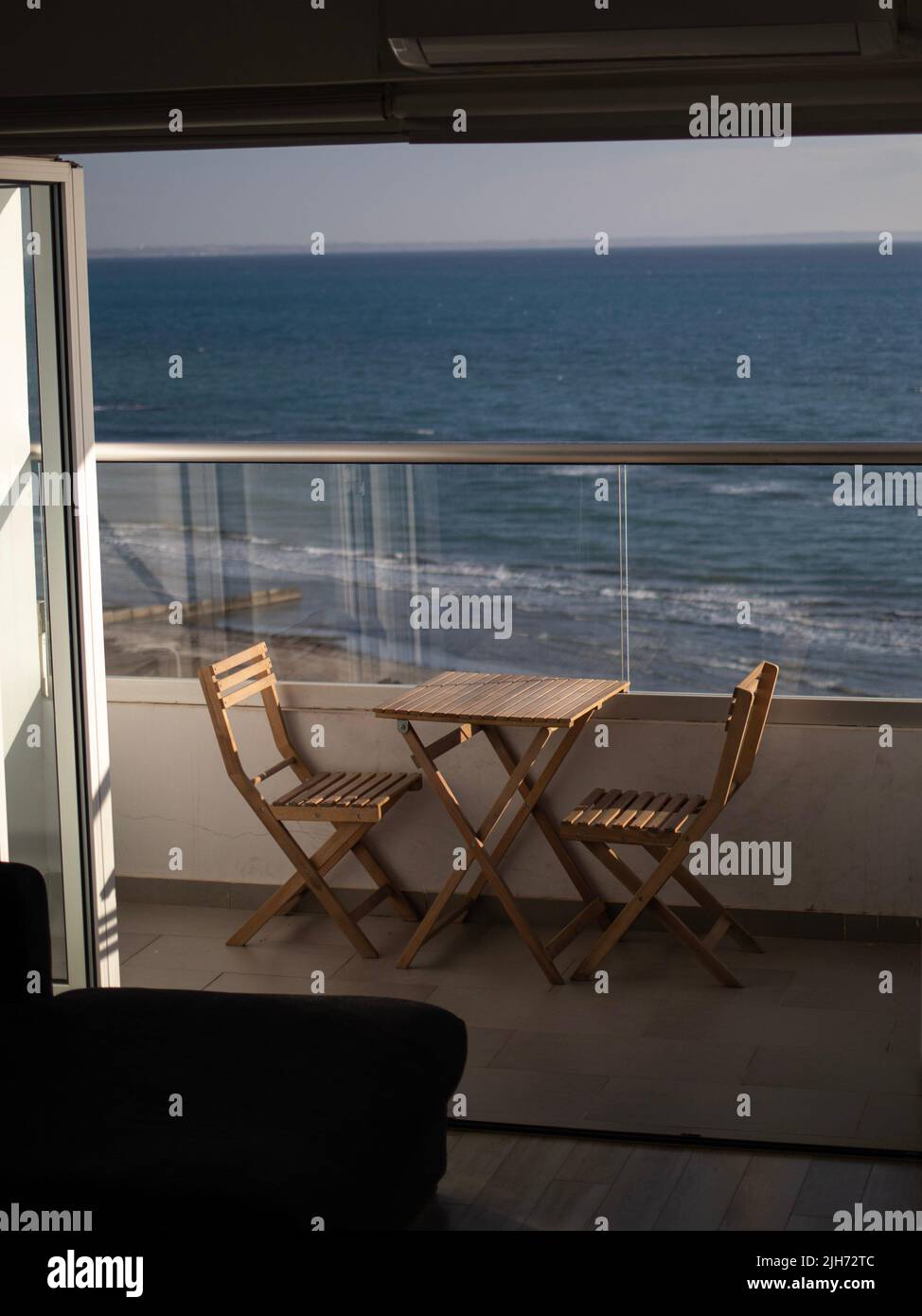 Cozy place at the balcony with sea background Stock Photo - Alamy