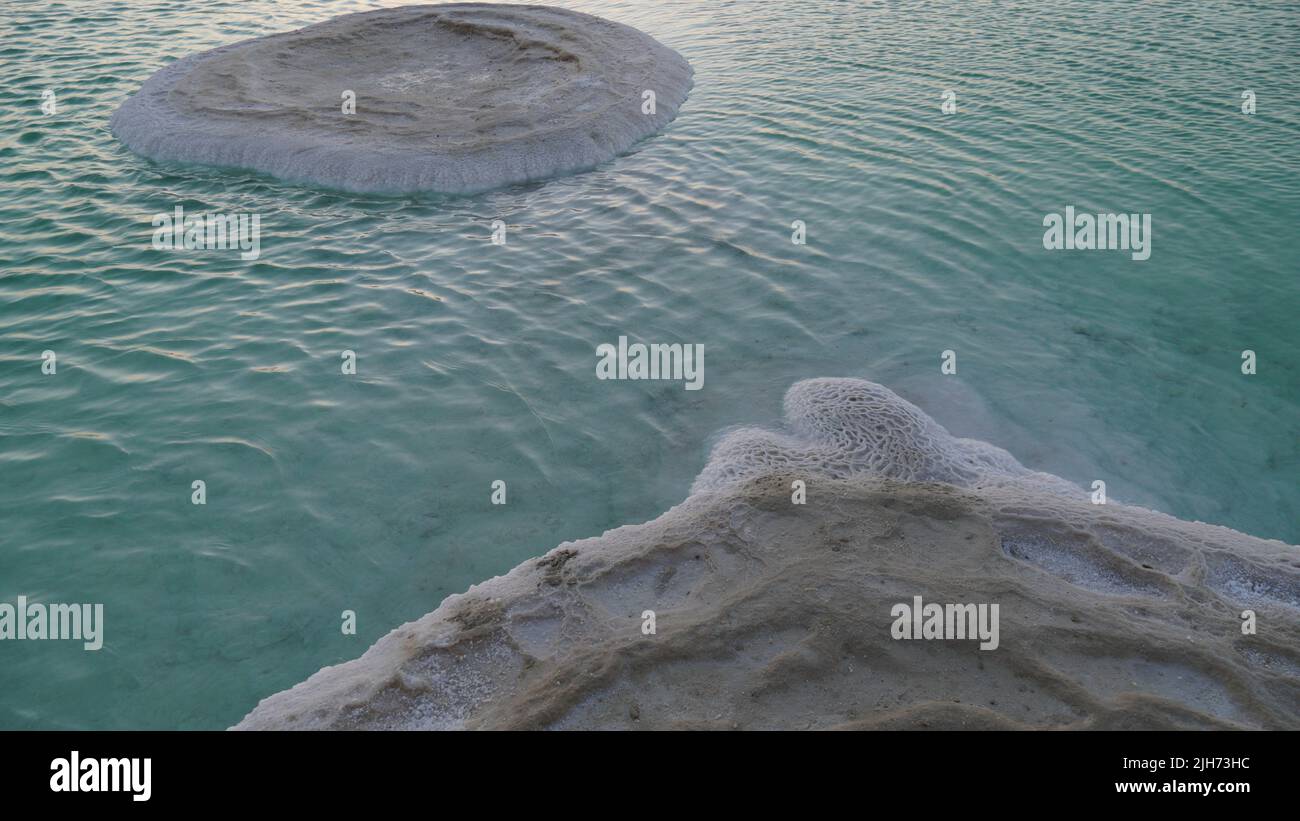 Large Salt accumulated on the shore of the Dead sea. Deposits of mineral salts, typical ...