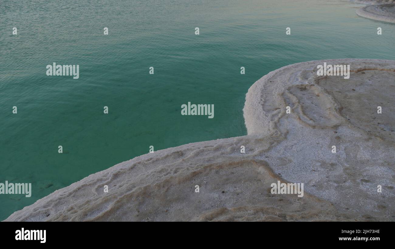 Large Salt accumulated on the shore of the Dead sea. Deposits of mineral salts, typical ...