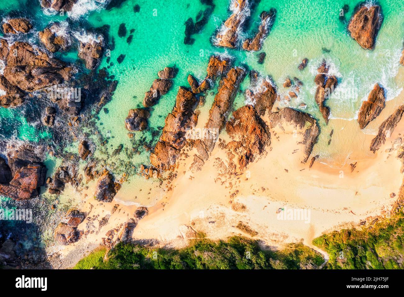 Emerald water and pristine sand of Burgess beach in Forster town of Australia on Pacific coast ...
