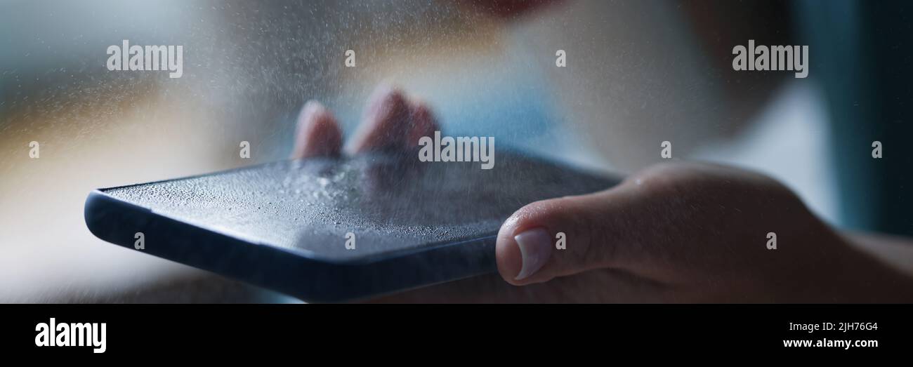 Spray antiseptic on mobile phone screen, antibacterial and disinfecting ...