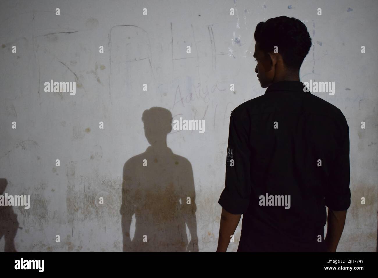 A man and his shadow . Concept -loneliness and depression Stock Photo ...
