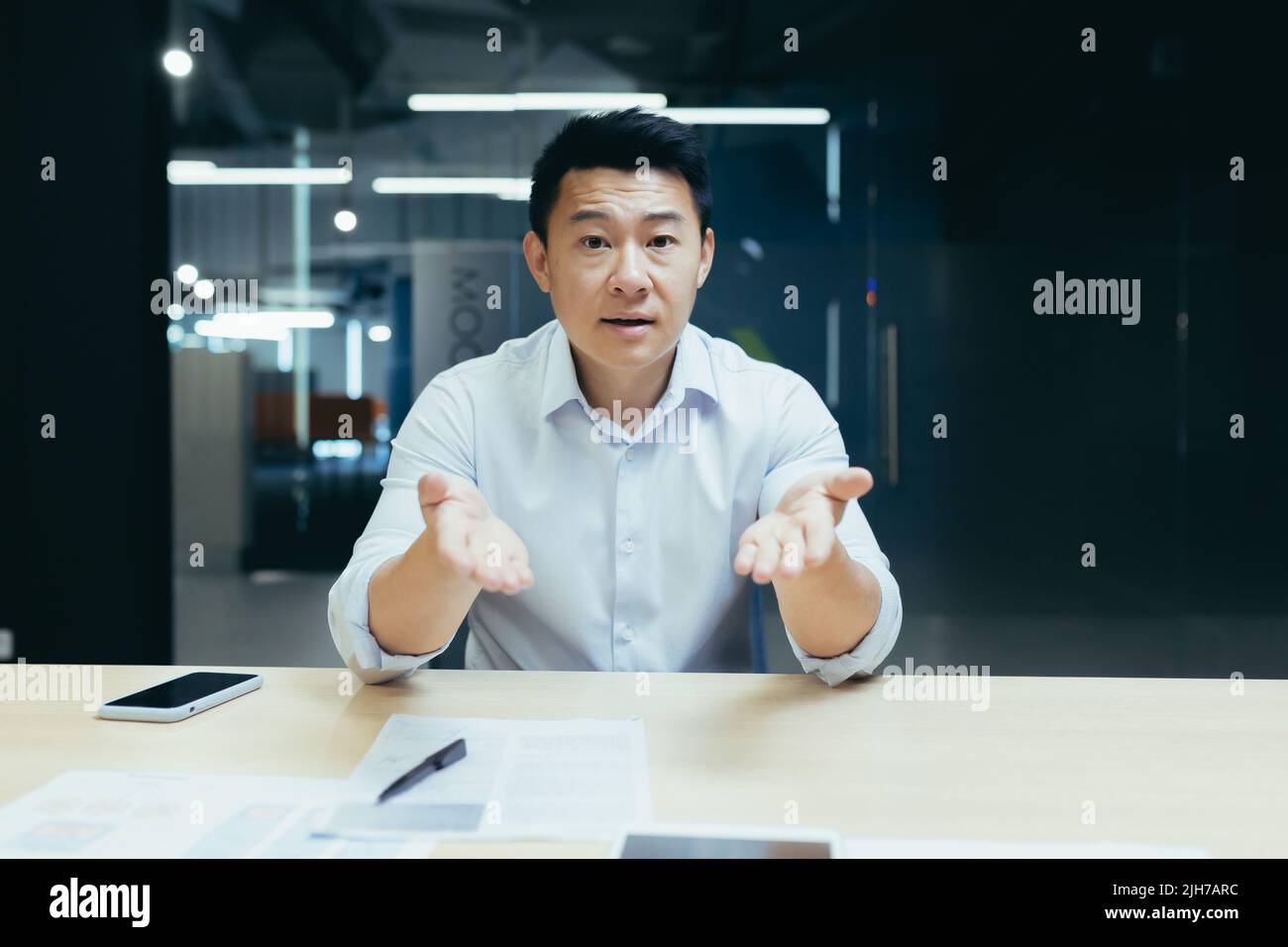 Online business training. Portrait of an active young Asian businessman ...