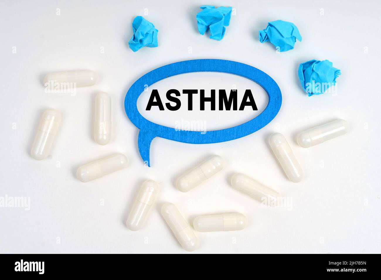 Medicine concept. On a white background pills, crumpled blue pieces of ...