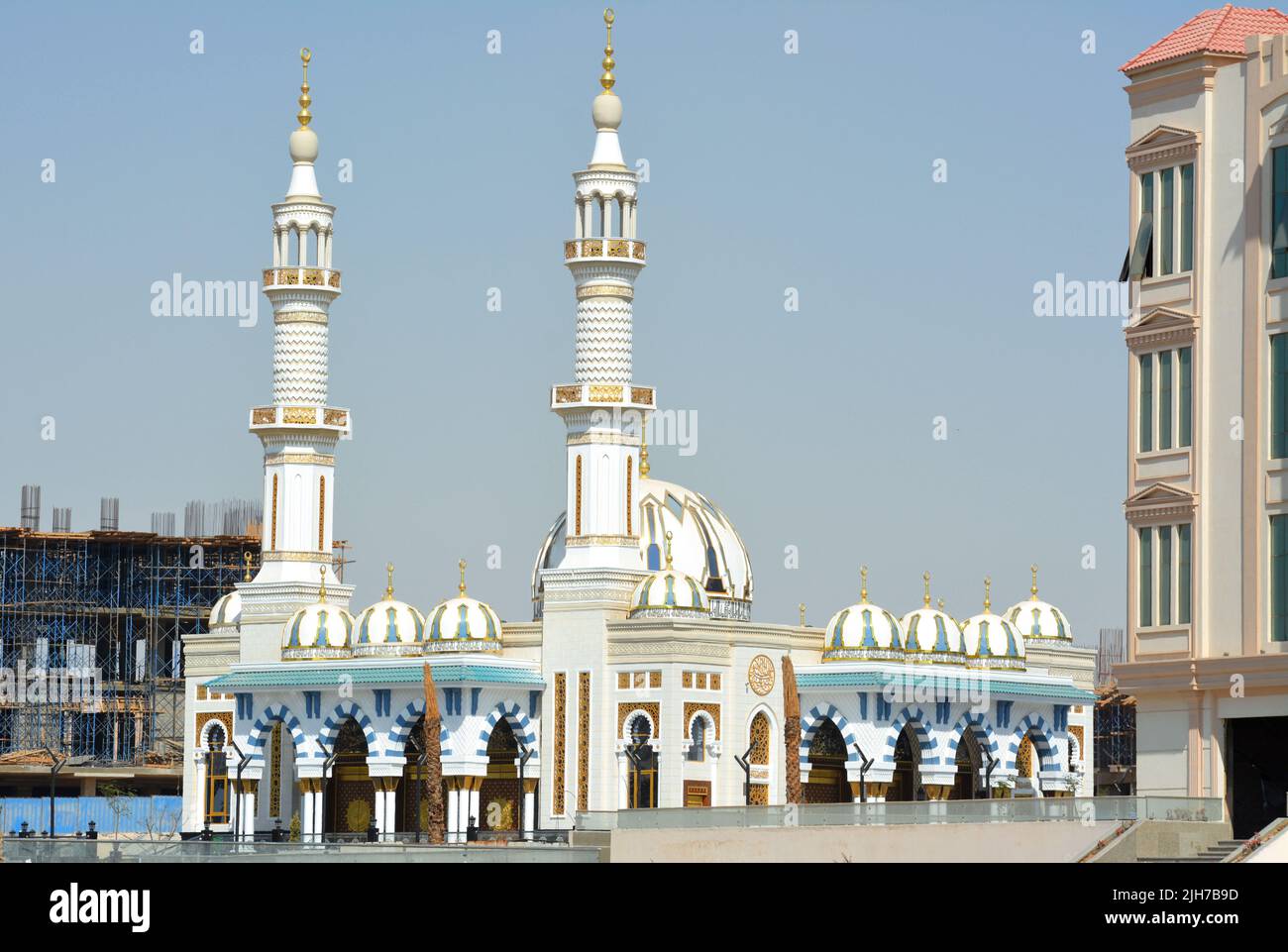 A beautiful white and blue mosque with multiple domes and minarets ...