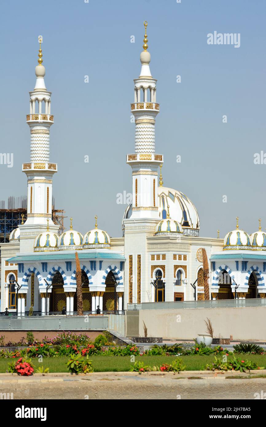 A beautiful white and blue mosque with multiple domes and minarets ...