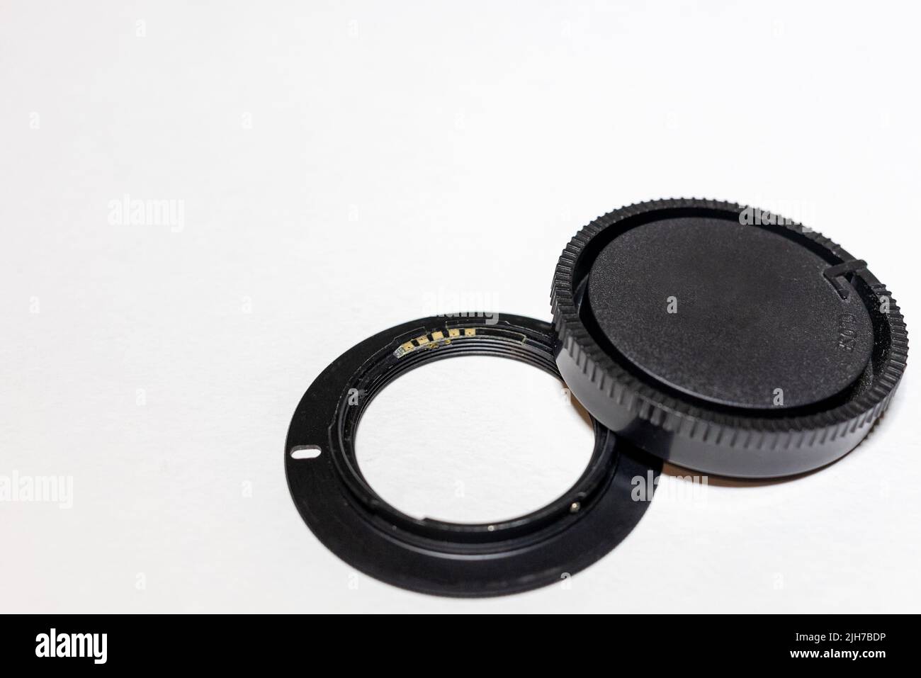 Sony lens adapter and cap on a white background. Copy space Stock Photo ...