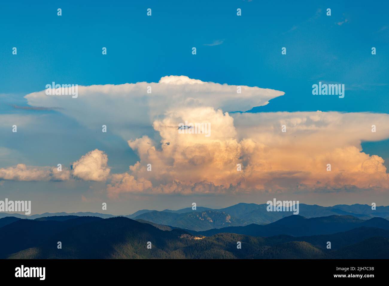 Huge majestic multi-colored and white clouds stretch across the bright ...