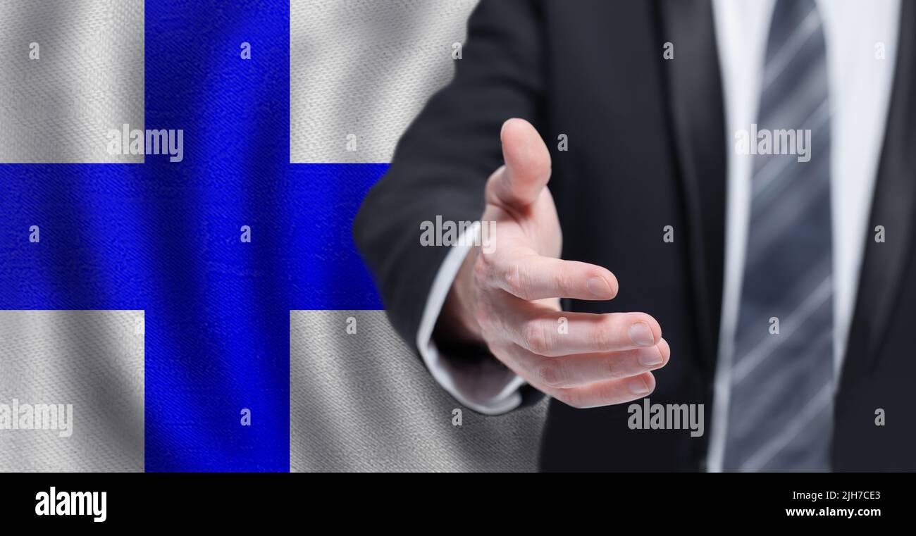 Welcome to the Finland. Hand on Finnish flag background. Business ...