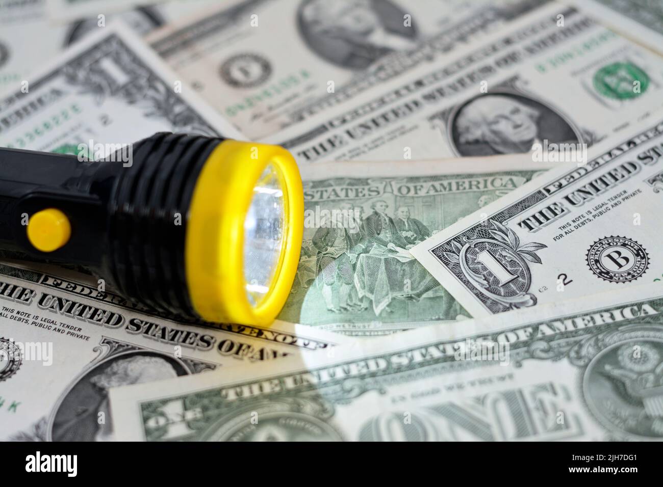 A yellow and black torch with a led light on a blurred background of ...