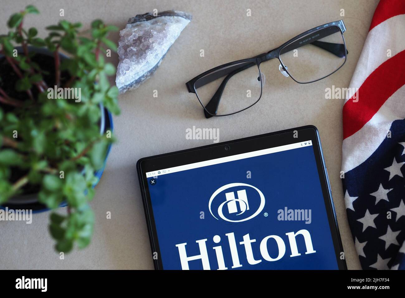 In this photo illustration, Hilton logo seen displayed on a tablet ...