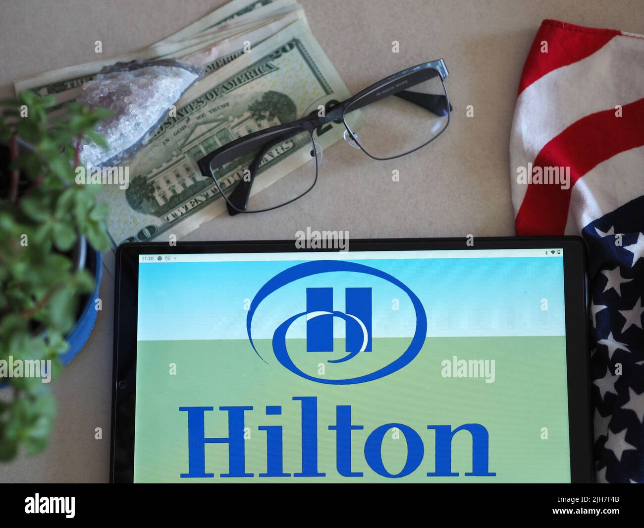 In this photo illustration, Hilton logo seen displayed on a tablet ...