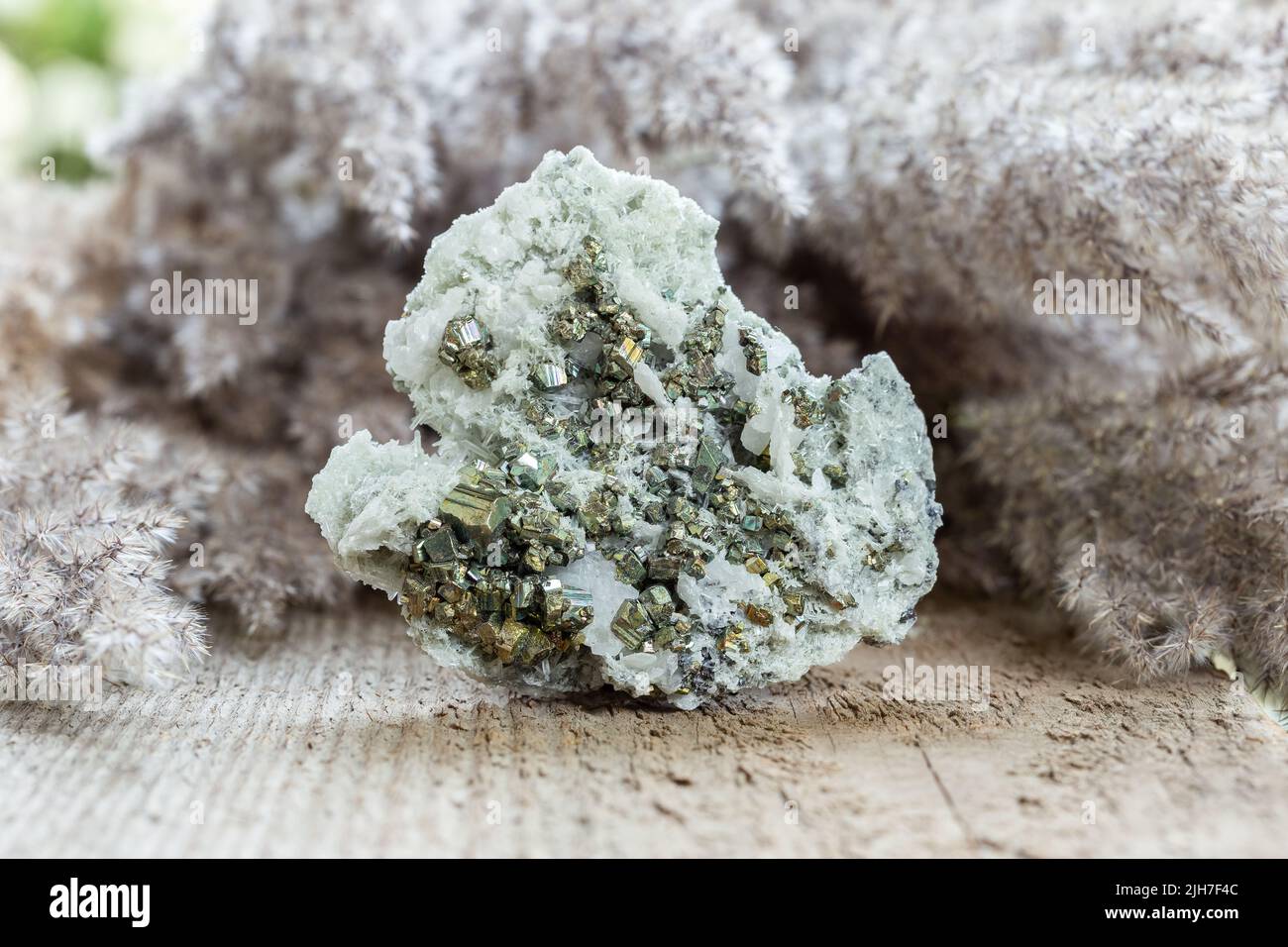 Raw Quartz and Pyrite mineral crystal structure on wooden background ...