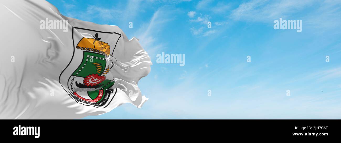 official flag of Pelalawan Regency Indonesia at cloudy sky background ...