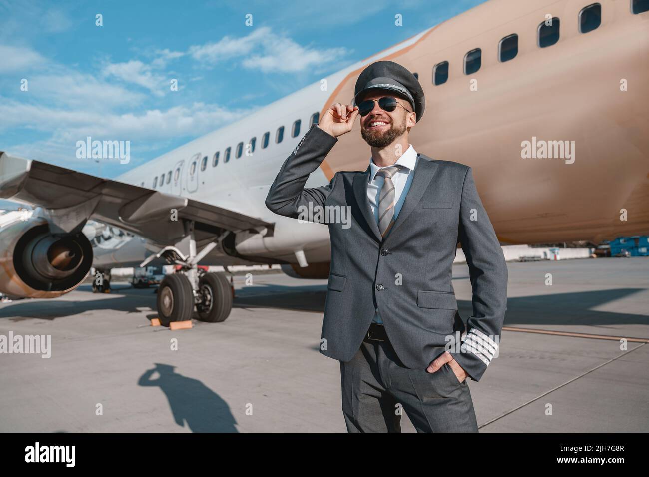 Cheerful aircraft pilot standing outdoors at airport Stock Photo - Alamy
