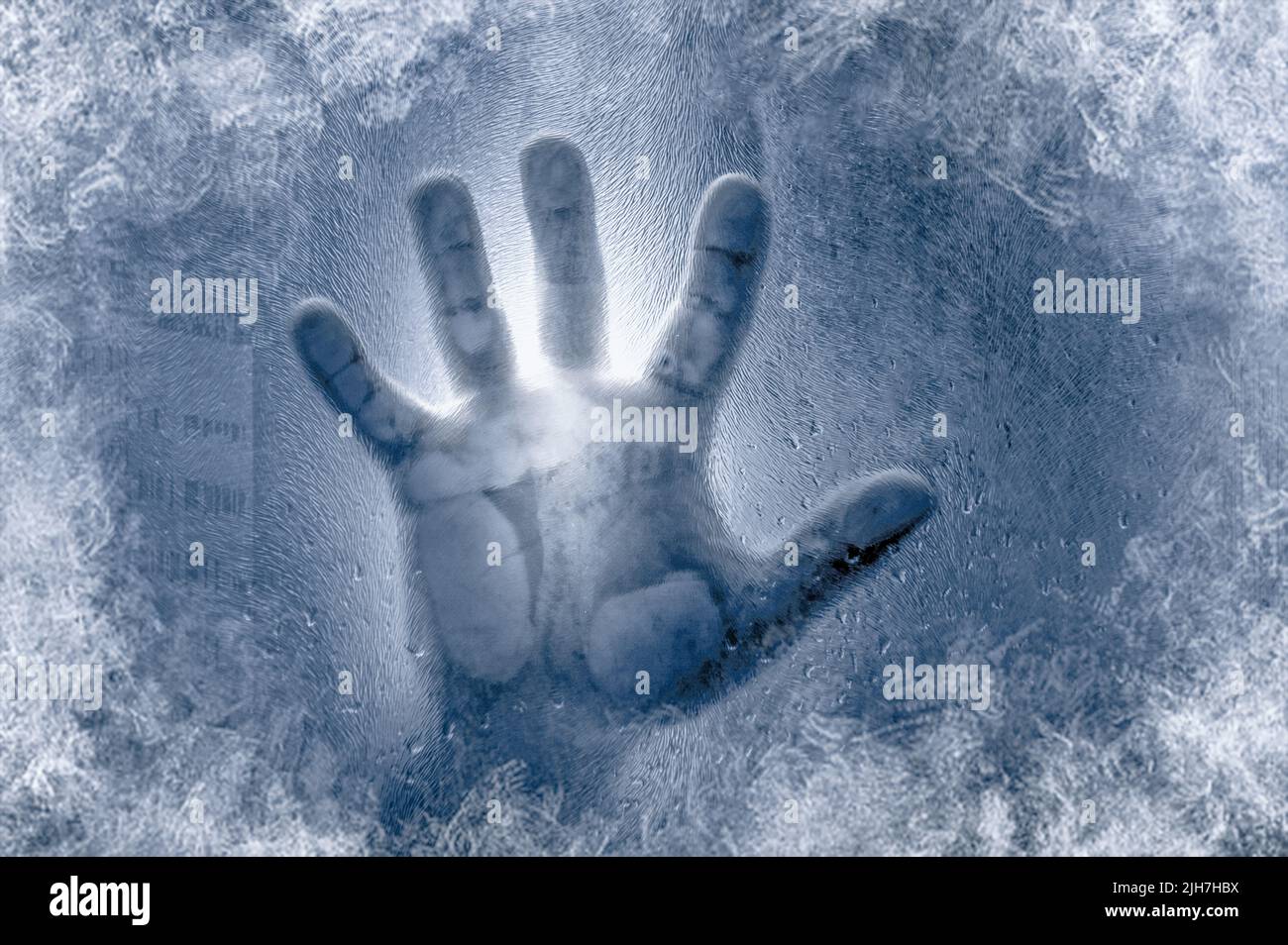 Human hand against frozen glass and blue background. Toned image ...