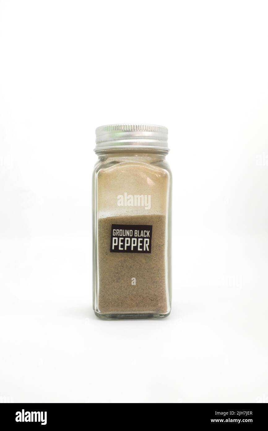 Ground black pepper powder in spice condiment glass bottle with label ...