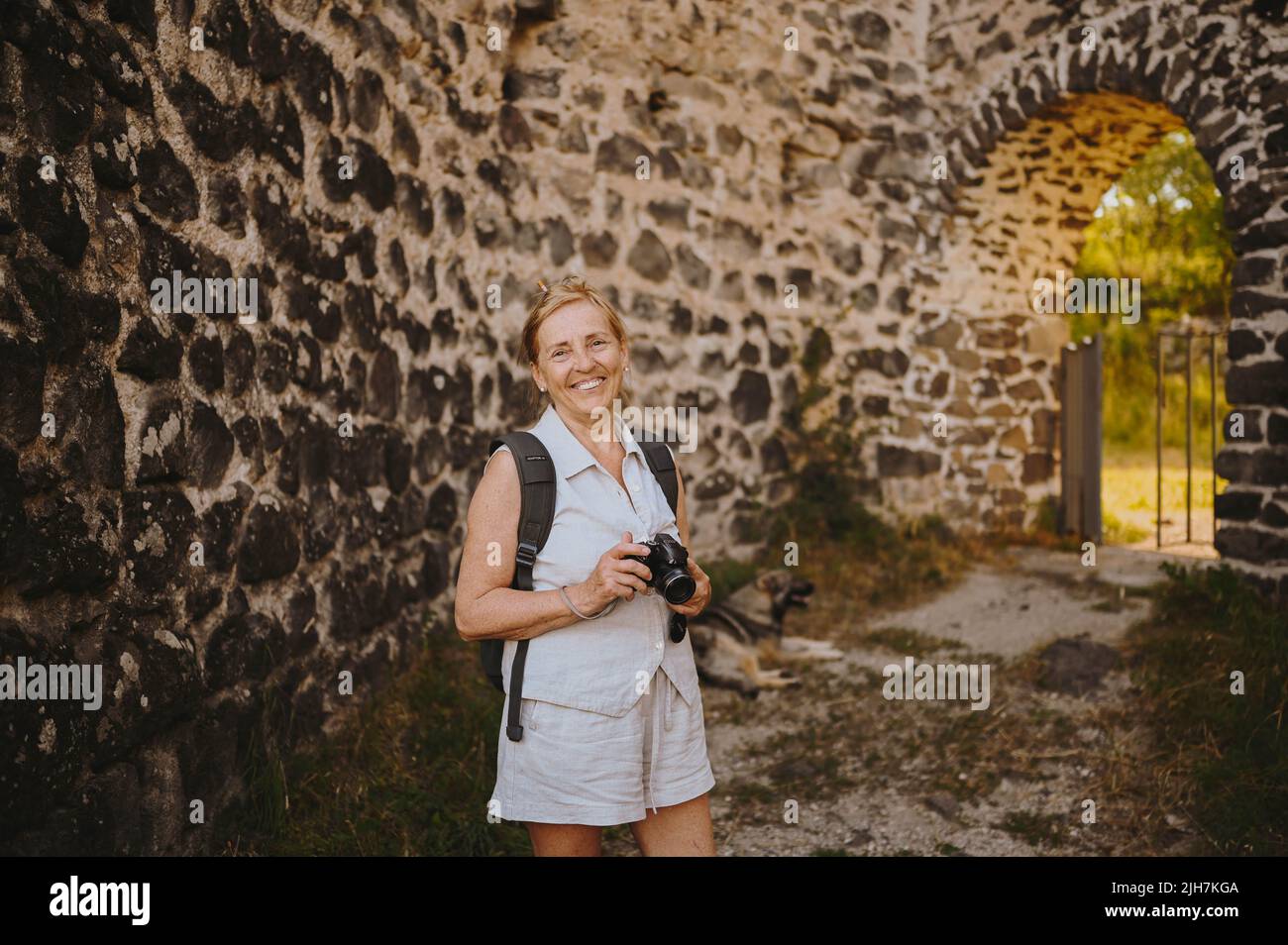 Elderly senior traveling backpacker mature woman tourist walking with ...