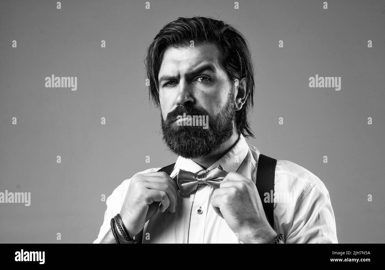 formal man wear suspenders and fix bow tie has well groomed hair and ...