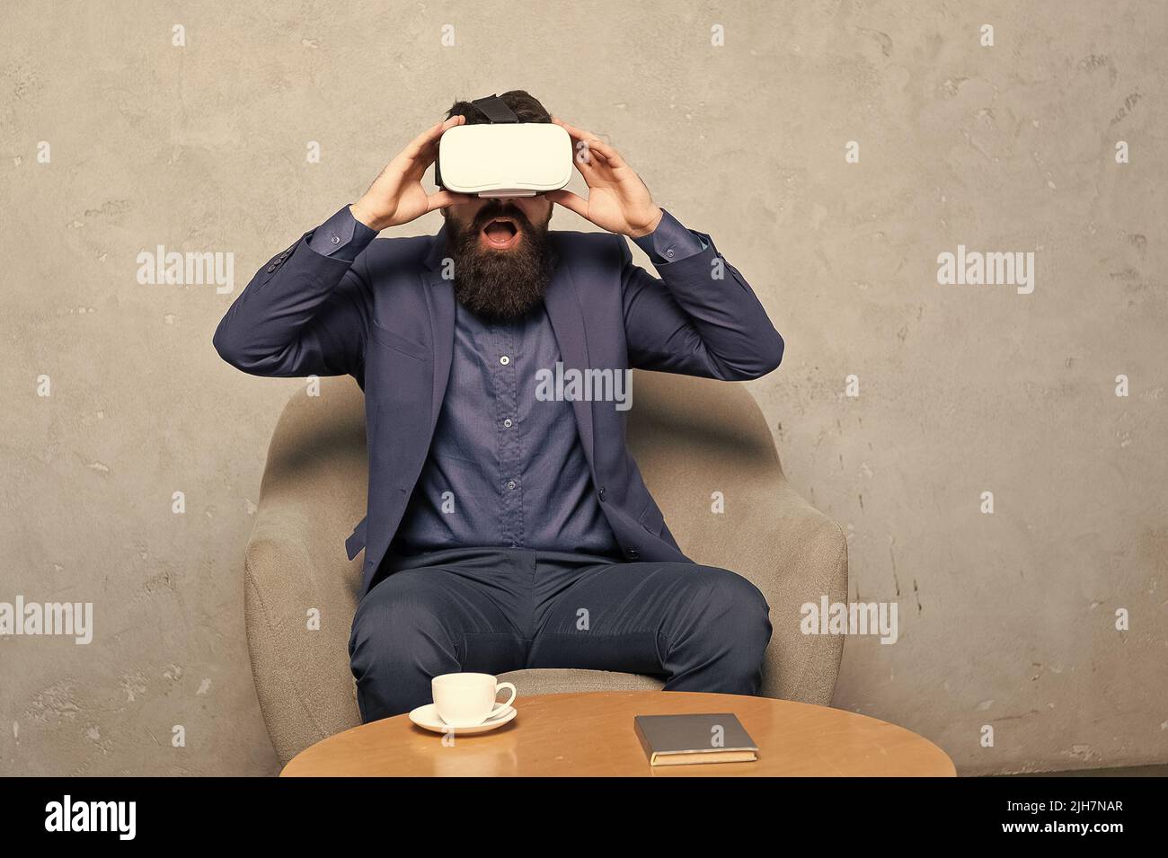 Lets go virtual. Shocked man director wear VR headset. Using virtual ...