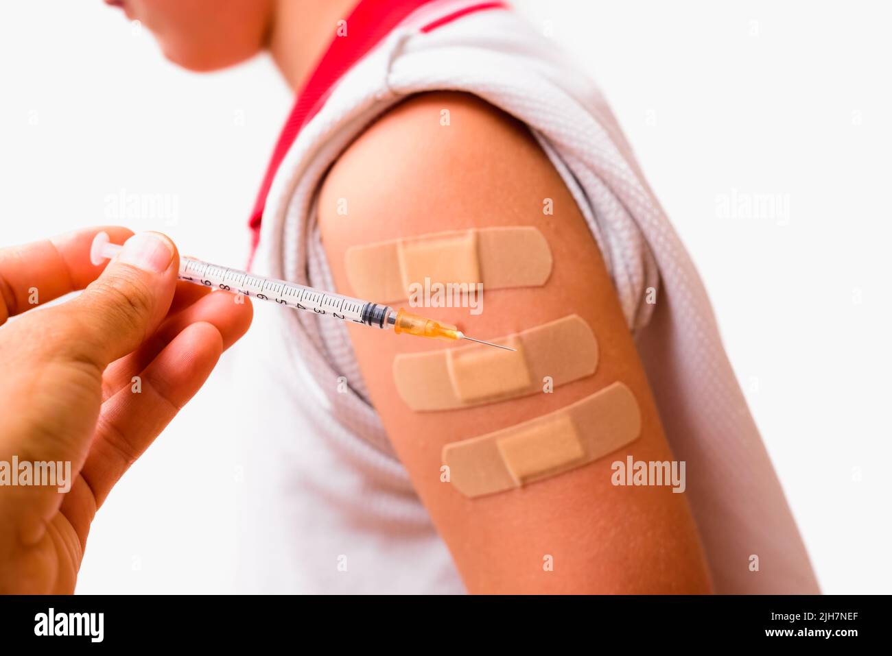 Child's arm with syringe and band aid Stock Photo - Alamy