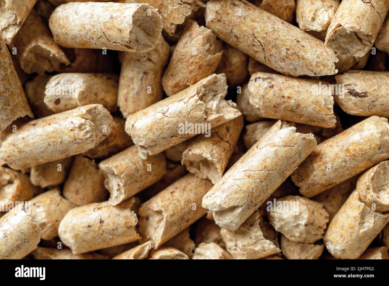 Macro background of wooden pellets. Compacted sawdust granules texture ...