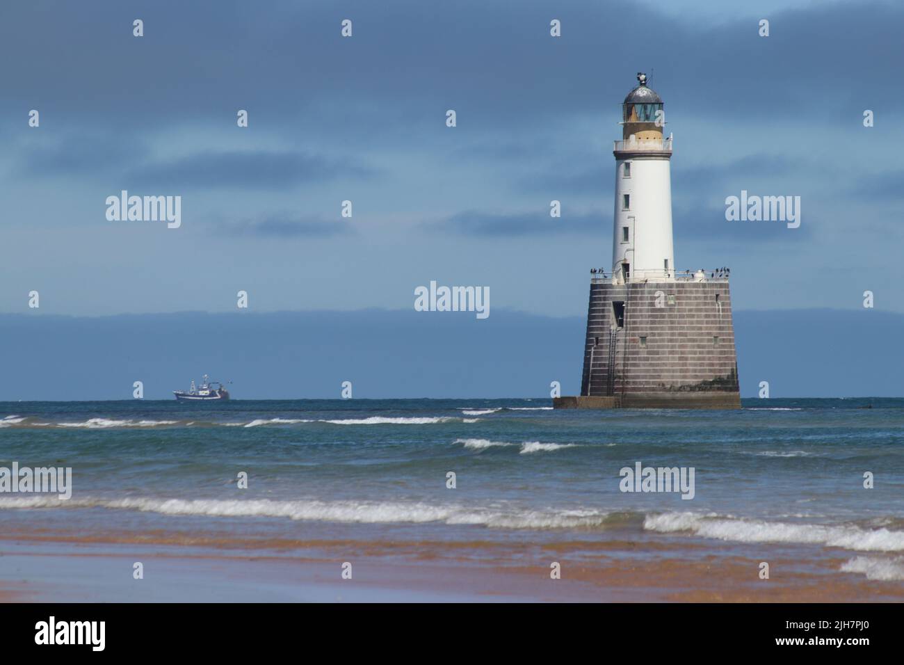 White lighthouse on platform in sea Stock Photo - Alamy
