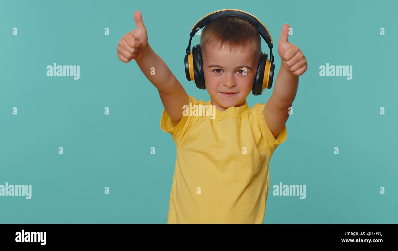 Happy little toddler children boy listening music via headphones ...