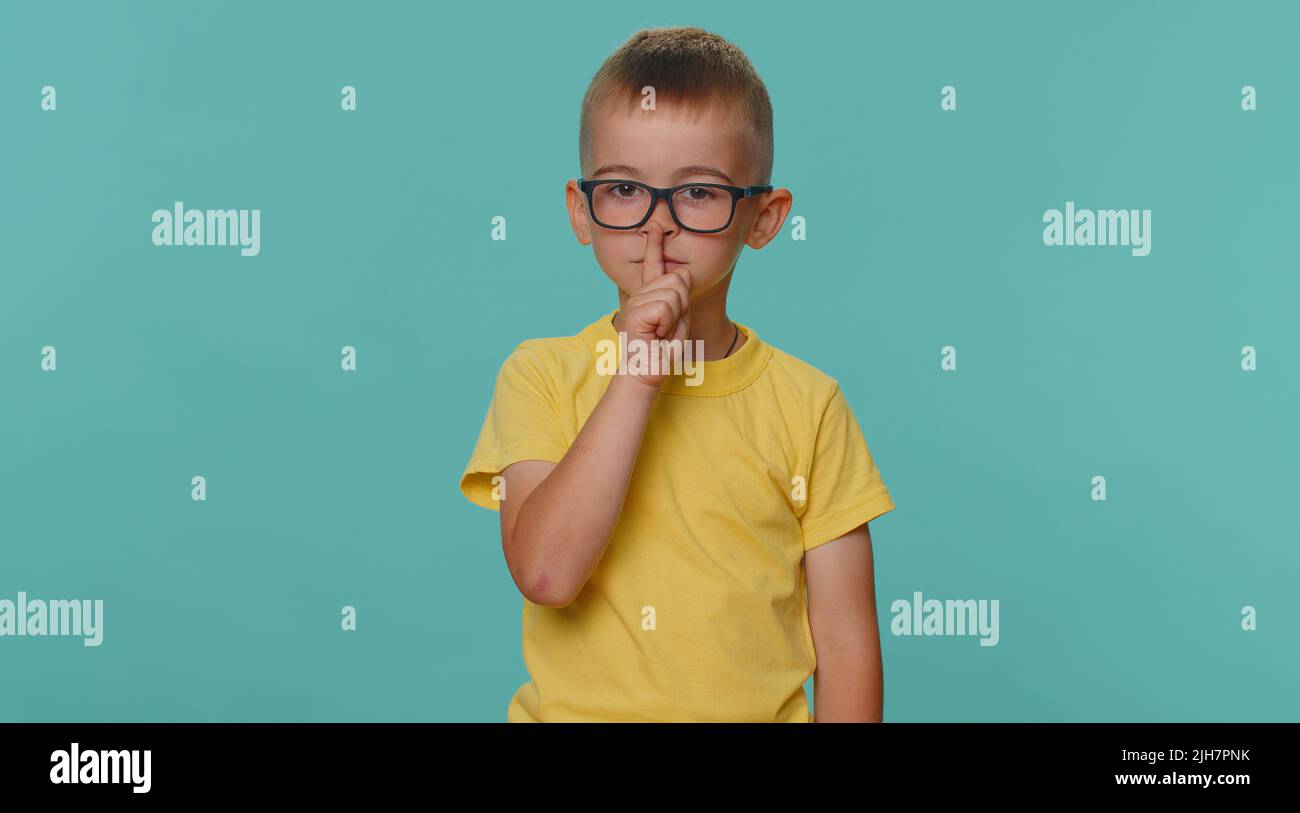 Shh be quiet please. Little toddler children boy presses index finger ...