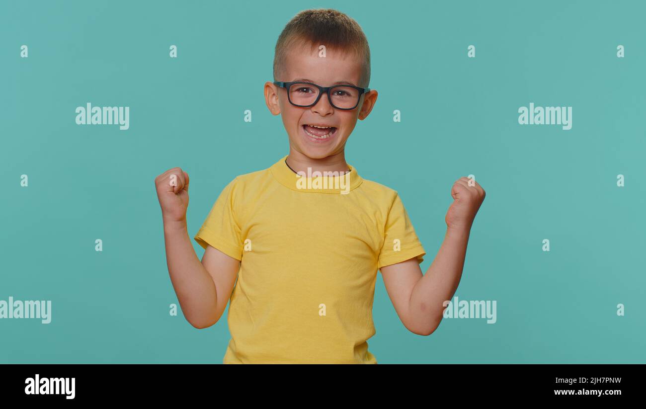 Happy little toddler children boy in t-shirt shouting, raising fists in ...