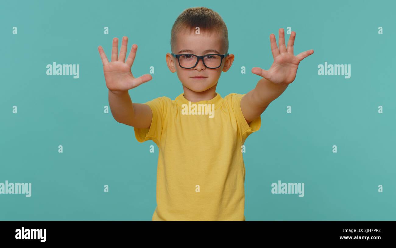 Stop gesture. Toddler children boy say no hold palm folded crossed ...