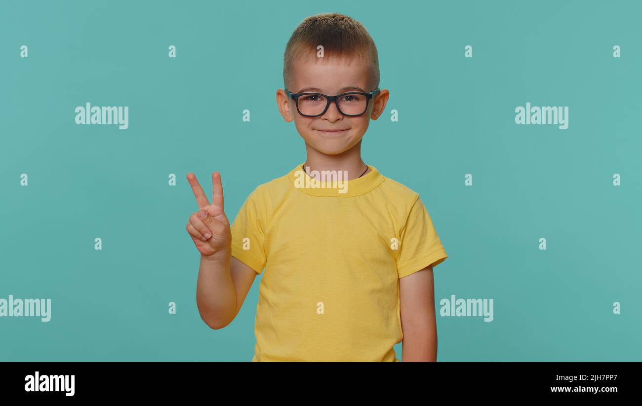 Happy smiling toddler children boy showing victory V sign, hoping for ...