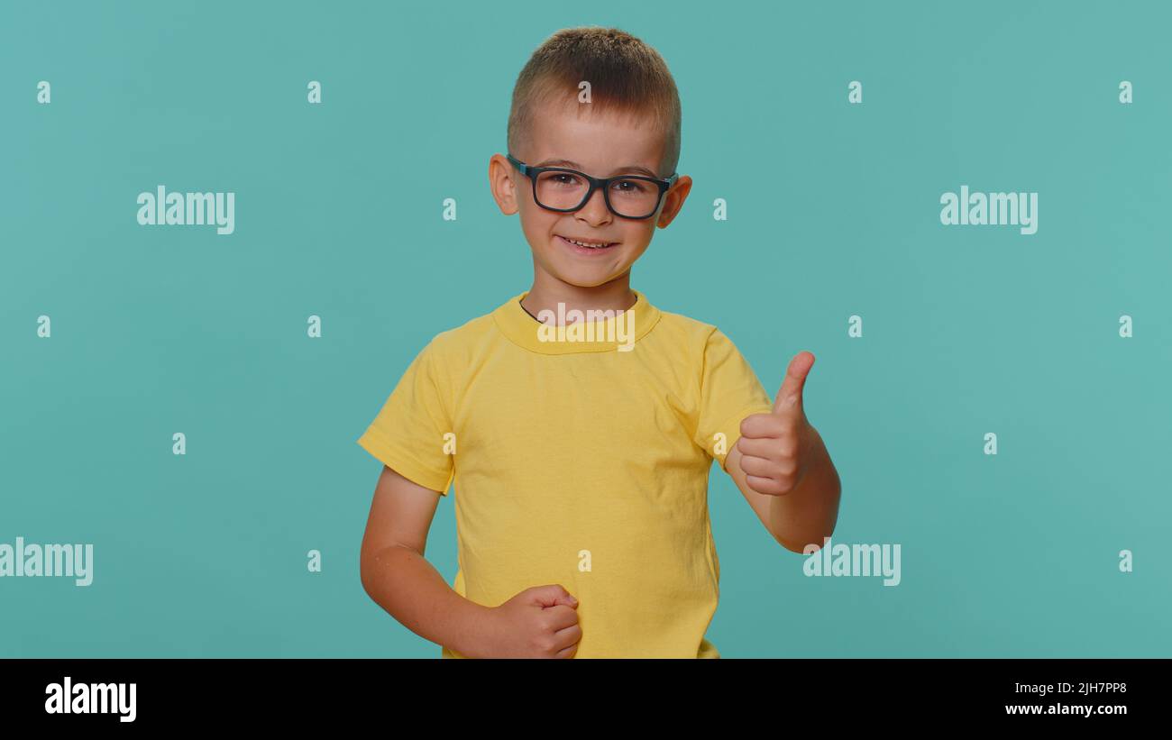 Like. Happy little toddler children boy raises thumbs up agrees with ...