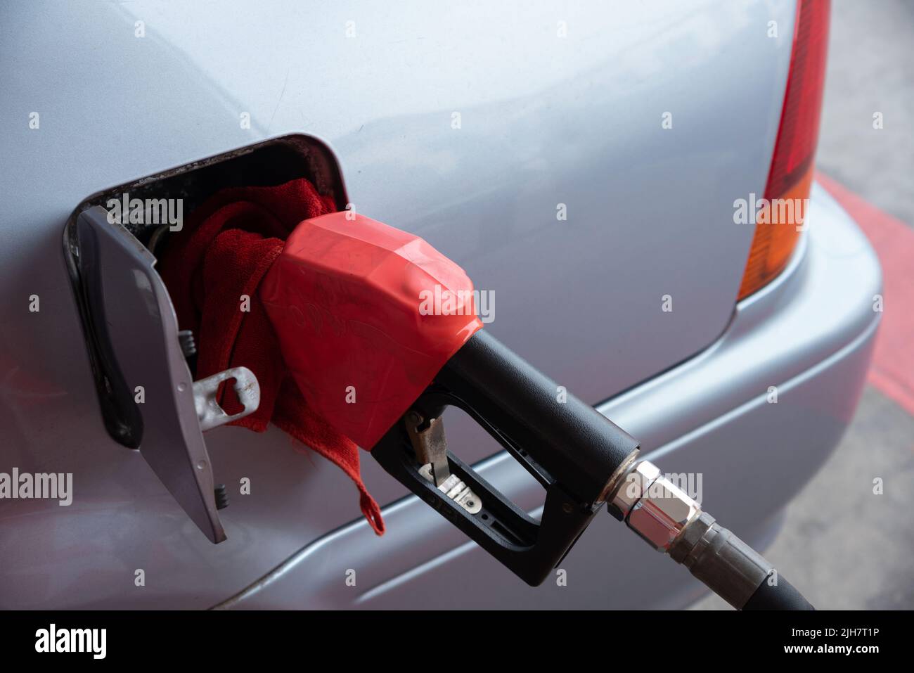 Fuel nozzle in the car tank. Refueling gasoline at petrol station Stock ...