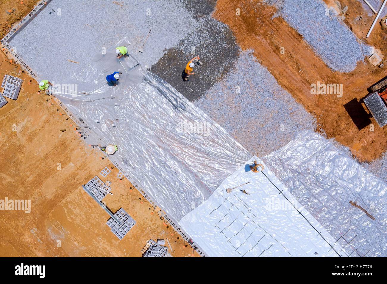 Installation of barrier plastic before pouring concrete construction ...