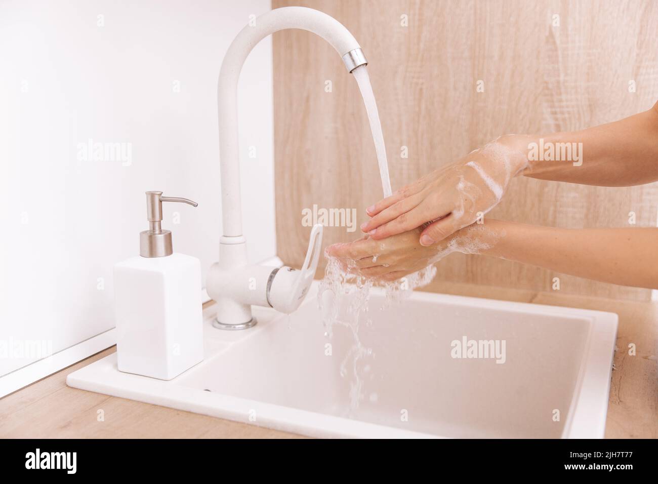 Washing hands under the flowing water tap. Hygiene concept hand detail ...