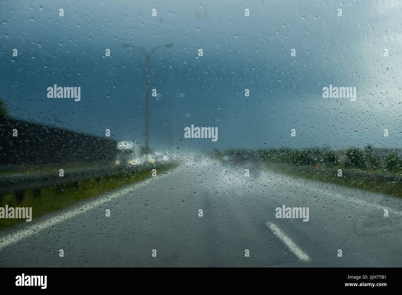 Driving the car on the highway during heavy rain. View from the front ...