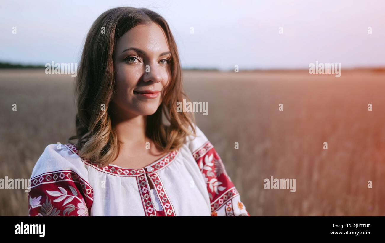 Smiling ukrainian woman in yellow ripe wheat field. Young lady in ...